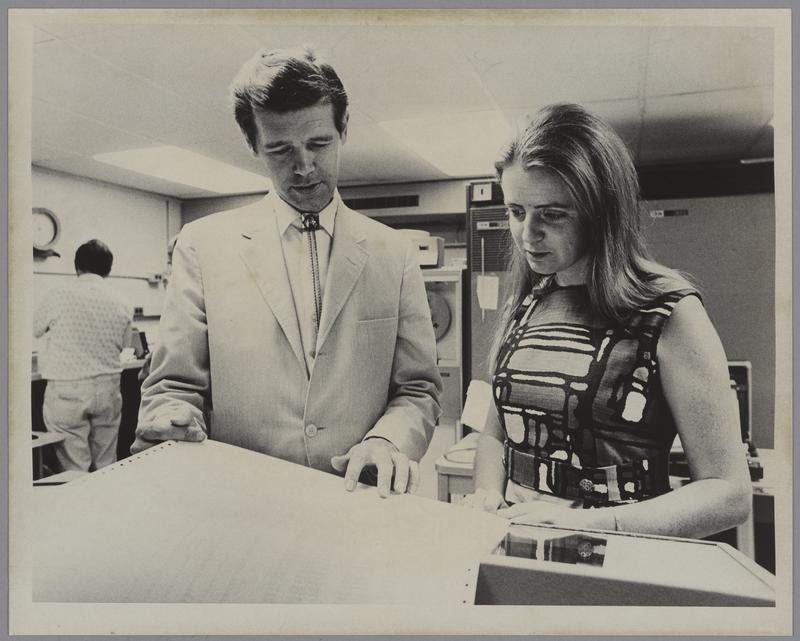 Catherine E. Costello and Klaus Biemann with printout, 1973 | MIT Museum